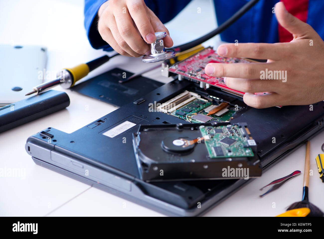 Repairman working in technical support fixing computer laptop ...