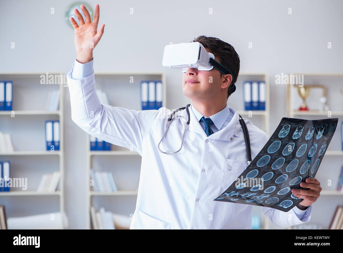 Young doctor looking at MRI scan through VR glasses Stock Photo - Alamy