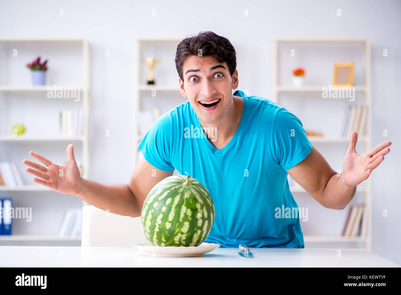 Man eating watermelon at home Stock Photo - Alamy