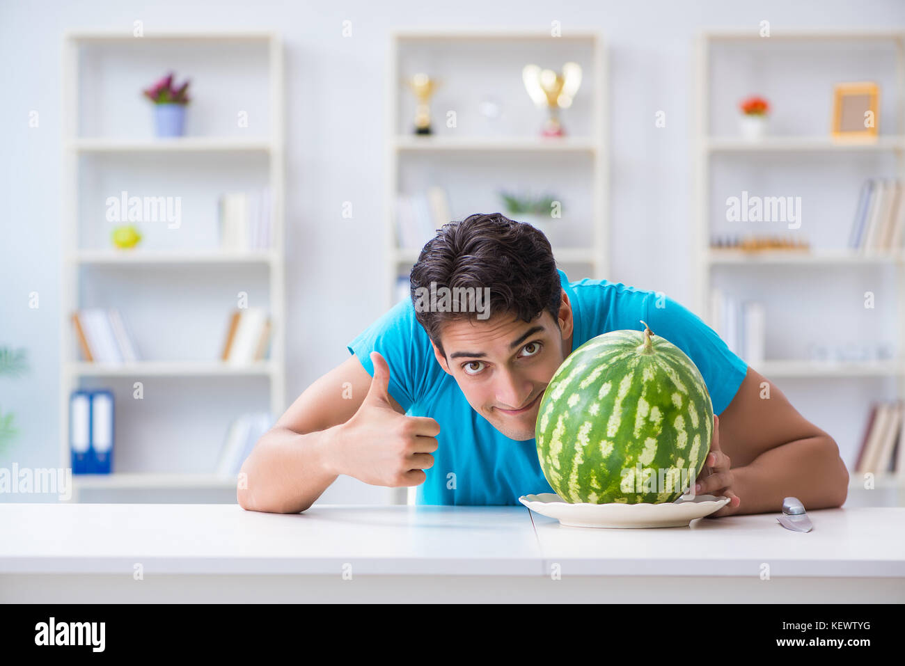 Man eating watermelon at home Stock Photo - Alamy