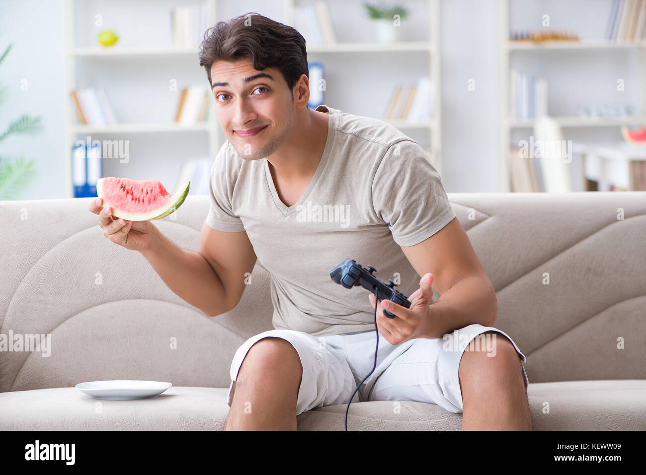 Man eating watermelon at home Stock Photo - Alamy