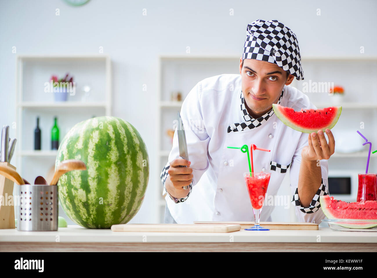 Male cook with watermelon in kitchen Stock Photo - Alamy
