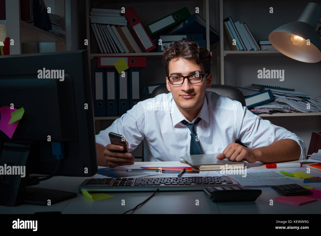 Man businessman working late hours in the office Stock Photo - Alamy