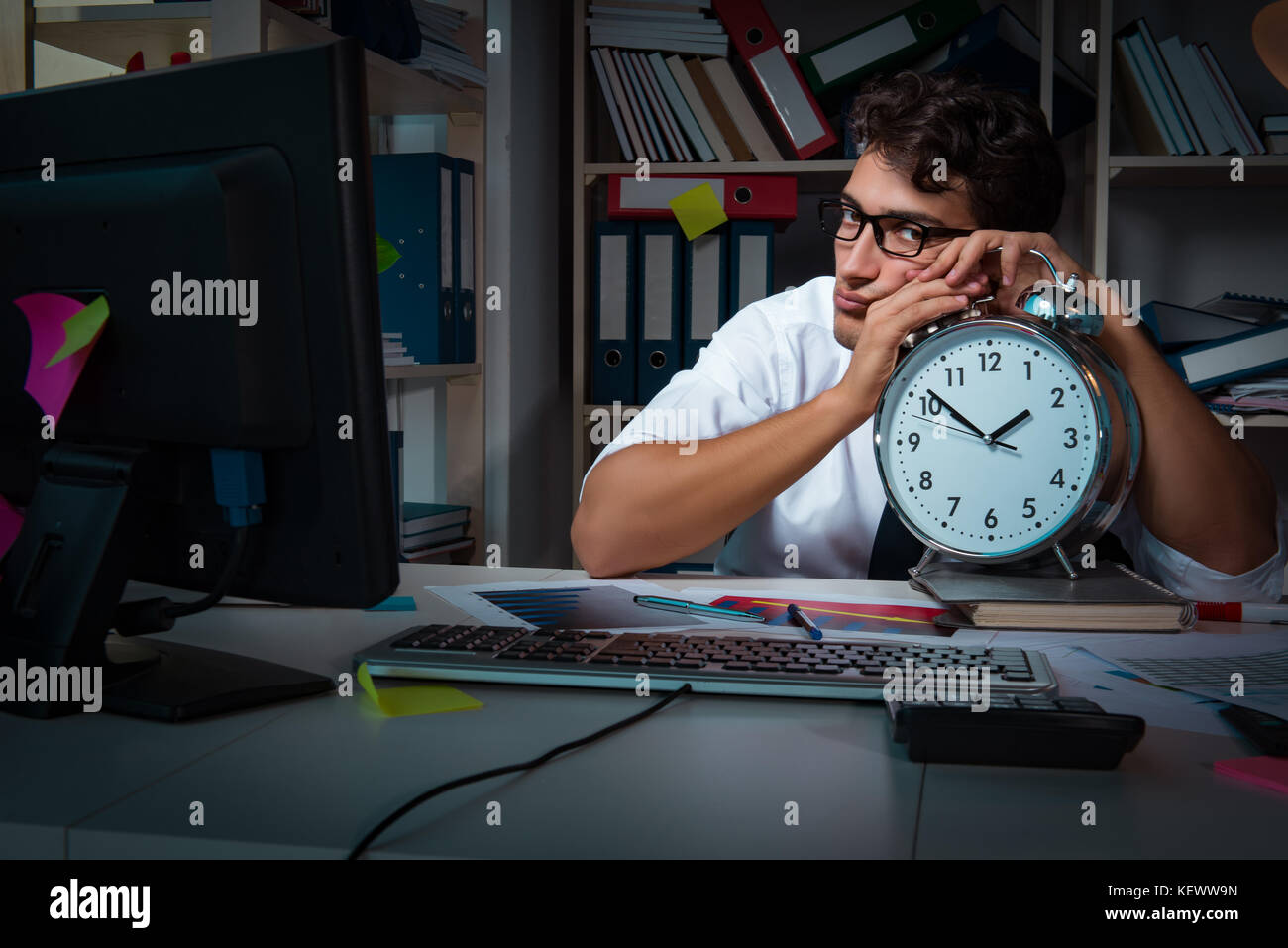 Man businessman working late hours in the office Stock Photo - Alamy