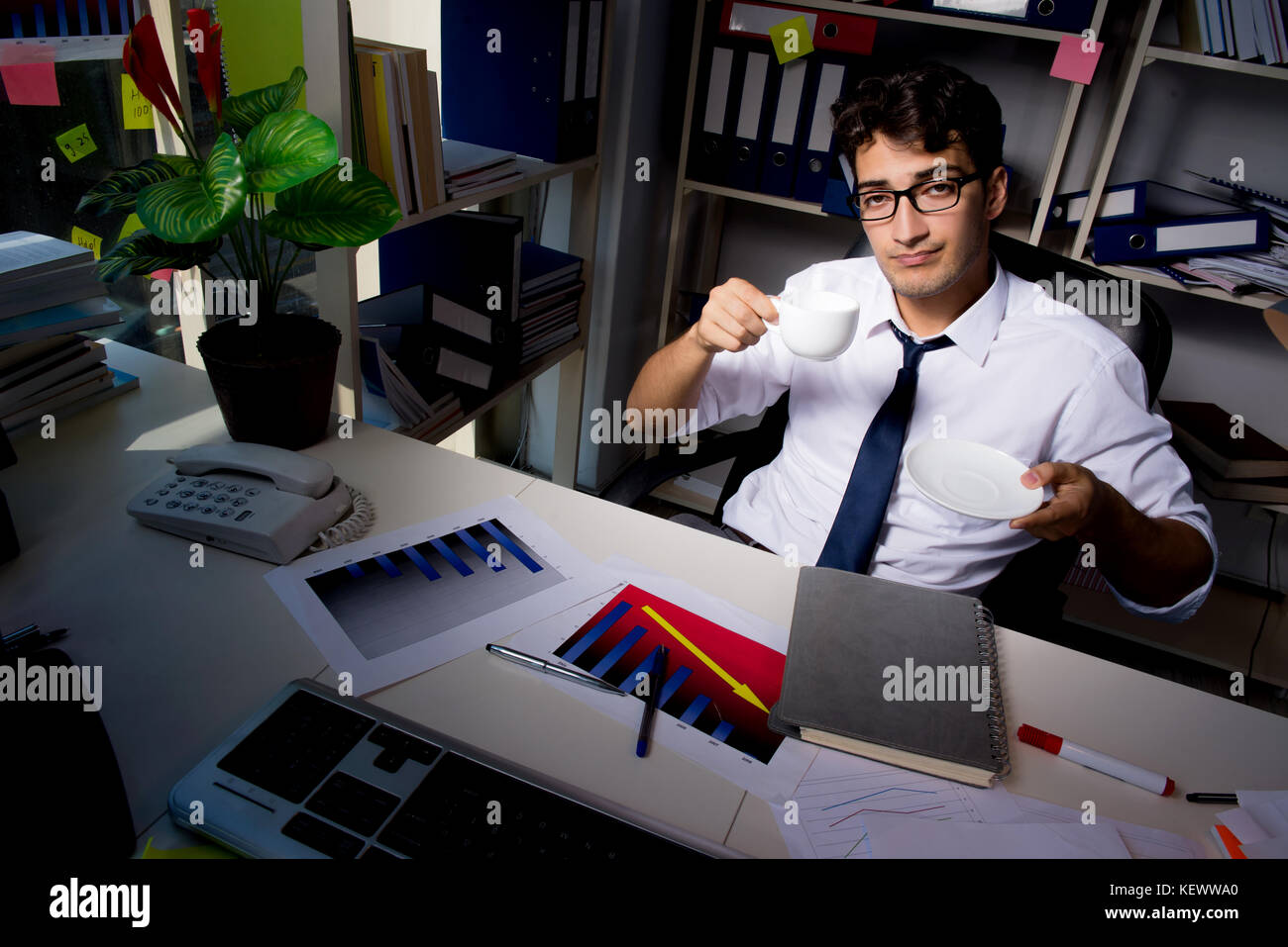Man businessman working late hours in the office Stock Photo - Alamy