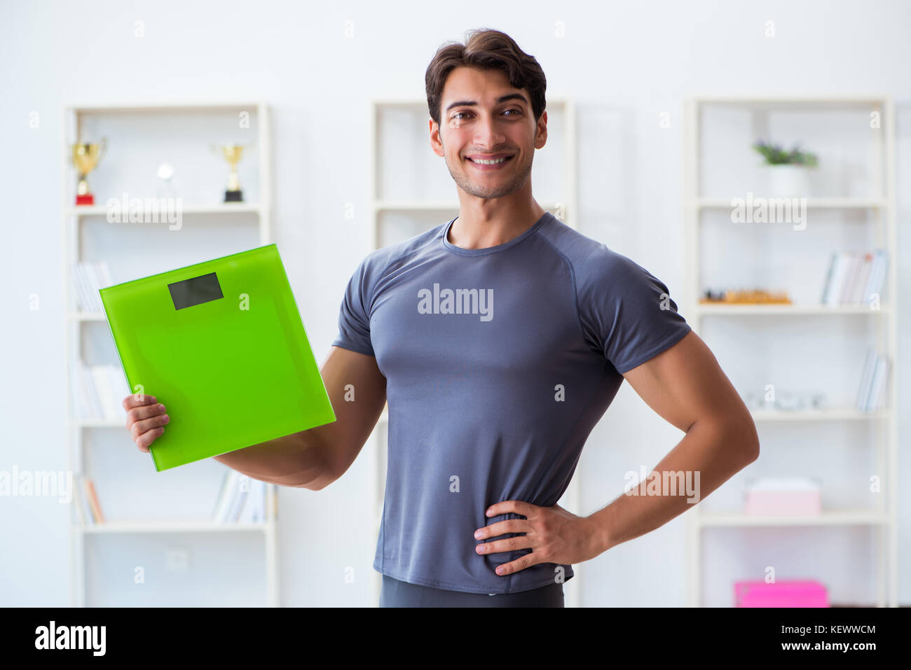 Man with scales in sports and health concept Stock Photo - Alamy