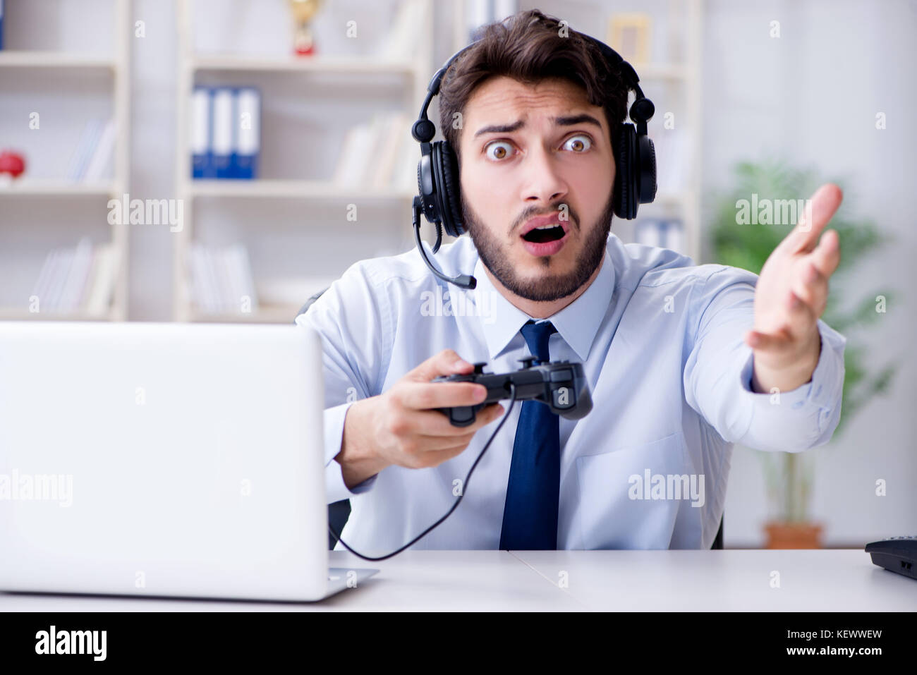 Businessman gamer in office playing games Stock Photo - Alamy