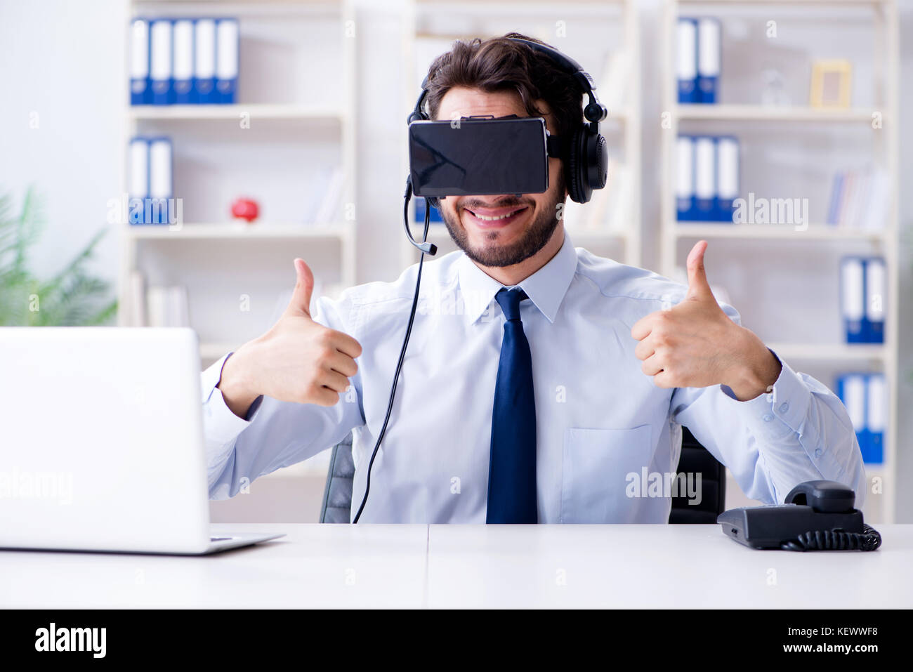 Businessman gamer in office playing games Stock Photo - Alamy