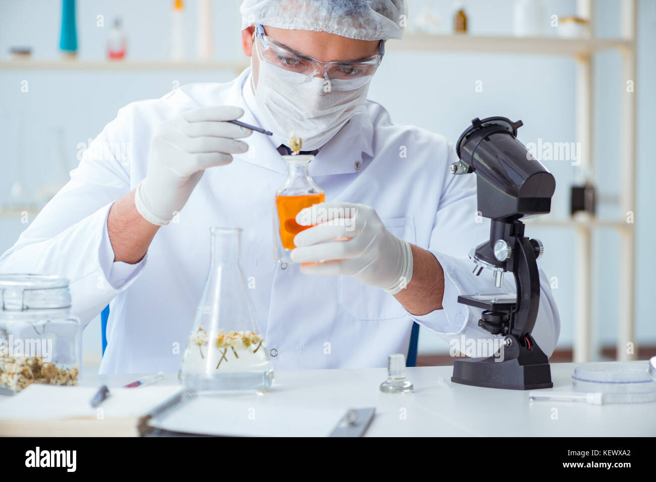 Chemist mixing perfumes in the lab Stock Photo - Alamy