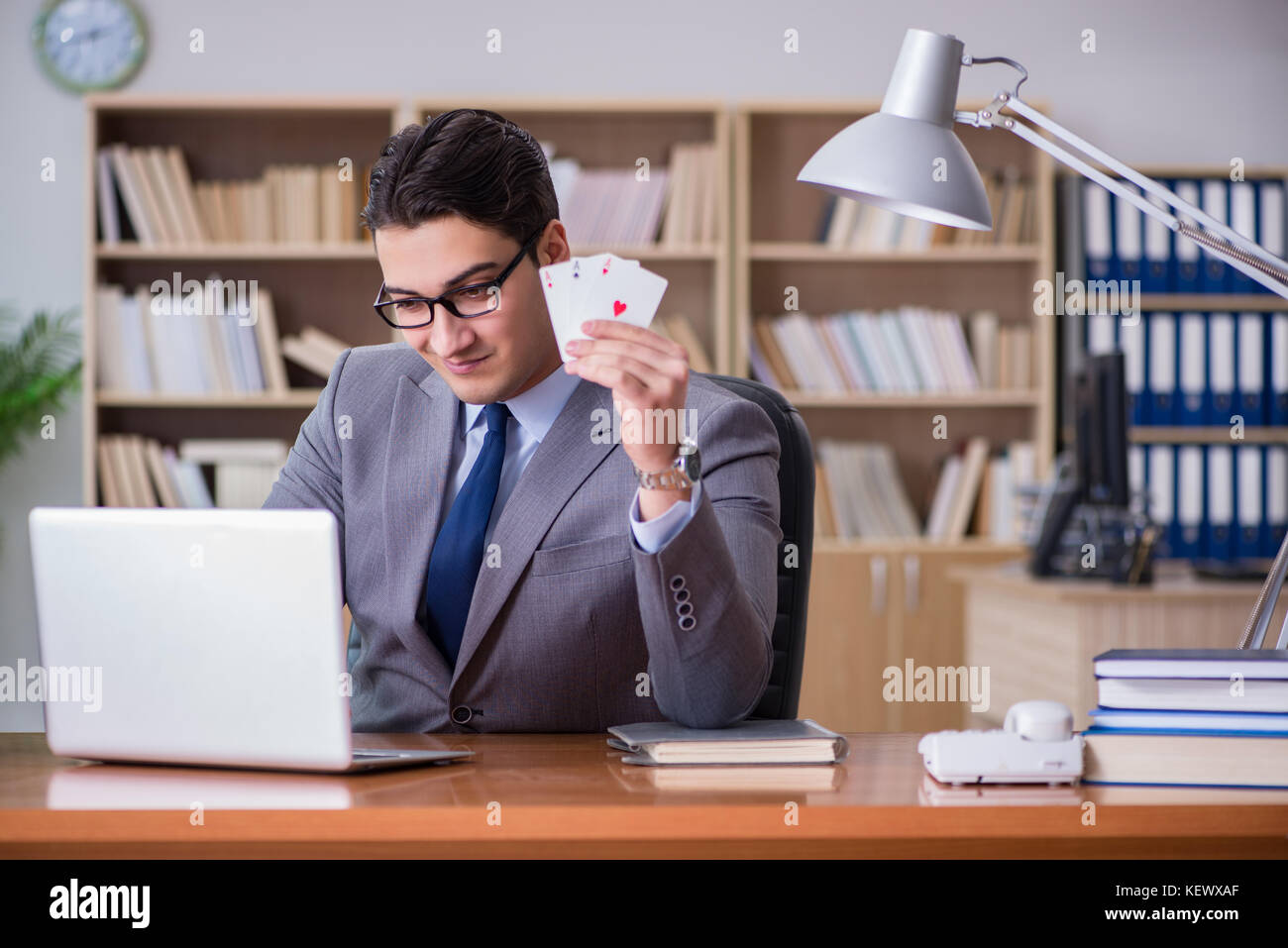 Businessman gambling playing cards at work Stock Photo - Alamy