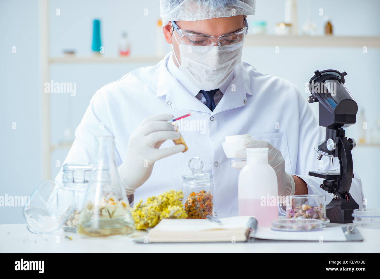 Chemist mixing perfumes in the lab Stock Photo - Alamy