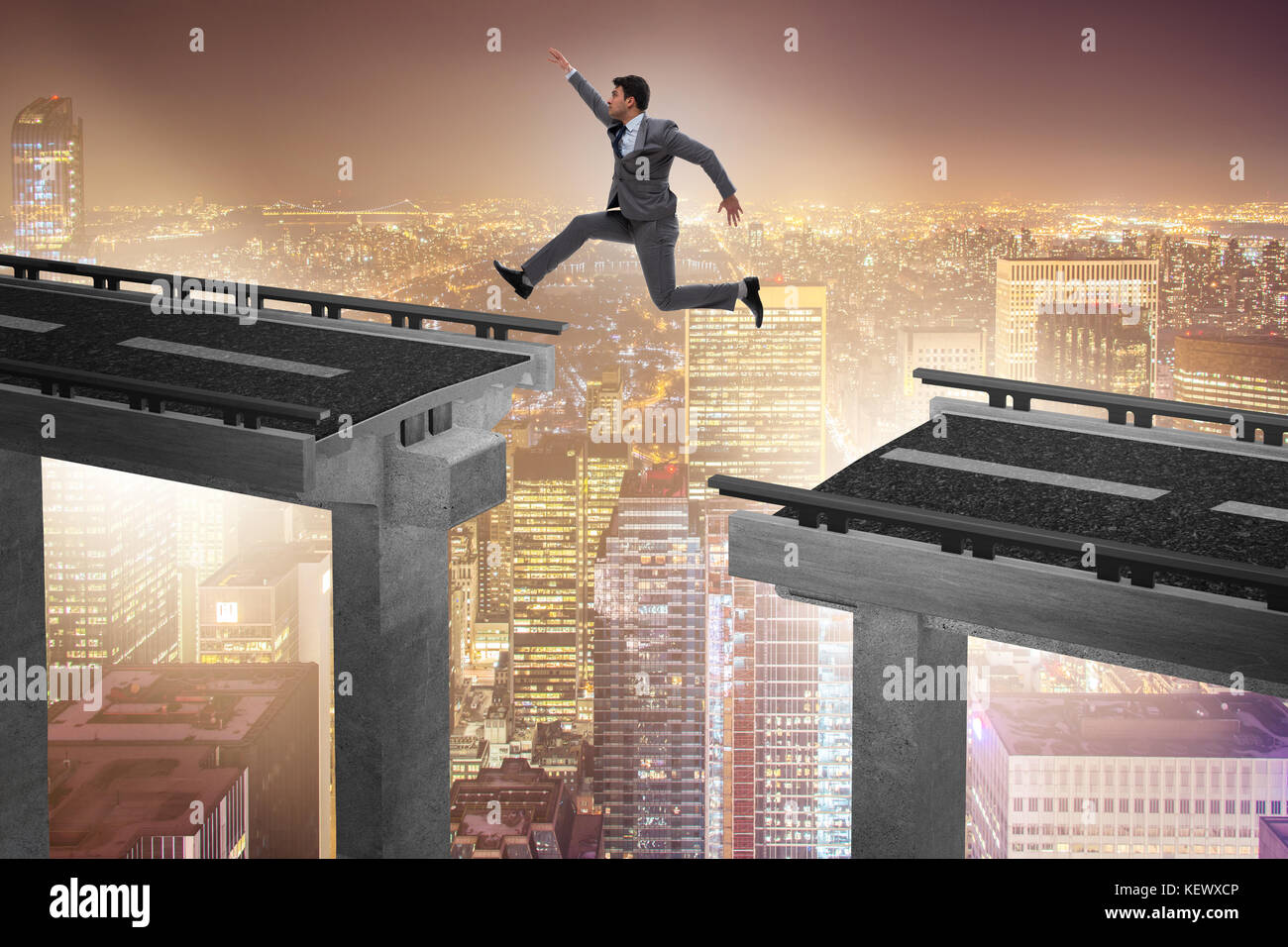 Young businessman jumping over the bridge Stock Photo - Alamy