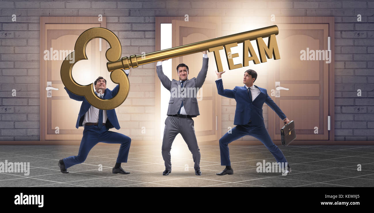 Businessmen holding giant key in team concept Stock Photo - Alamy