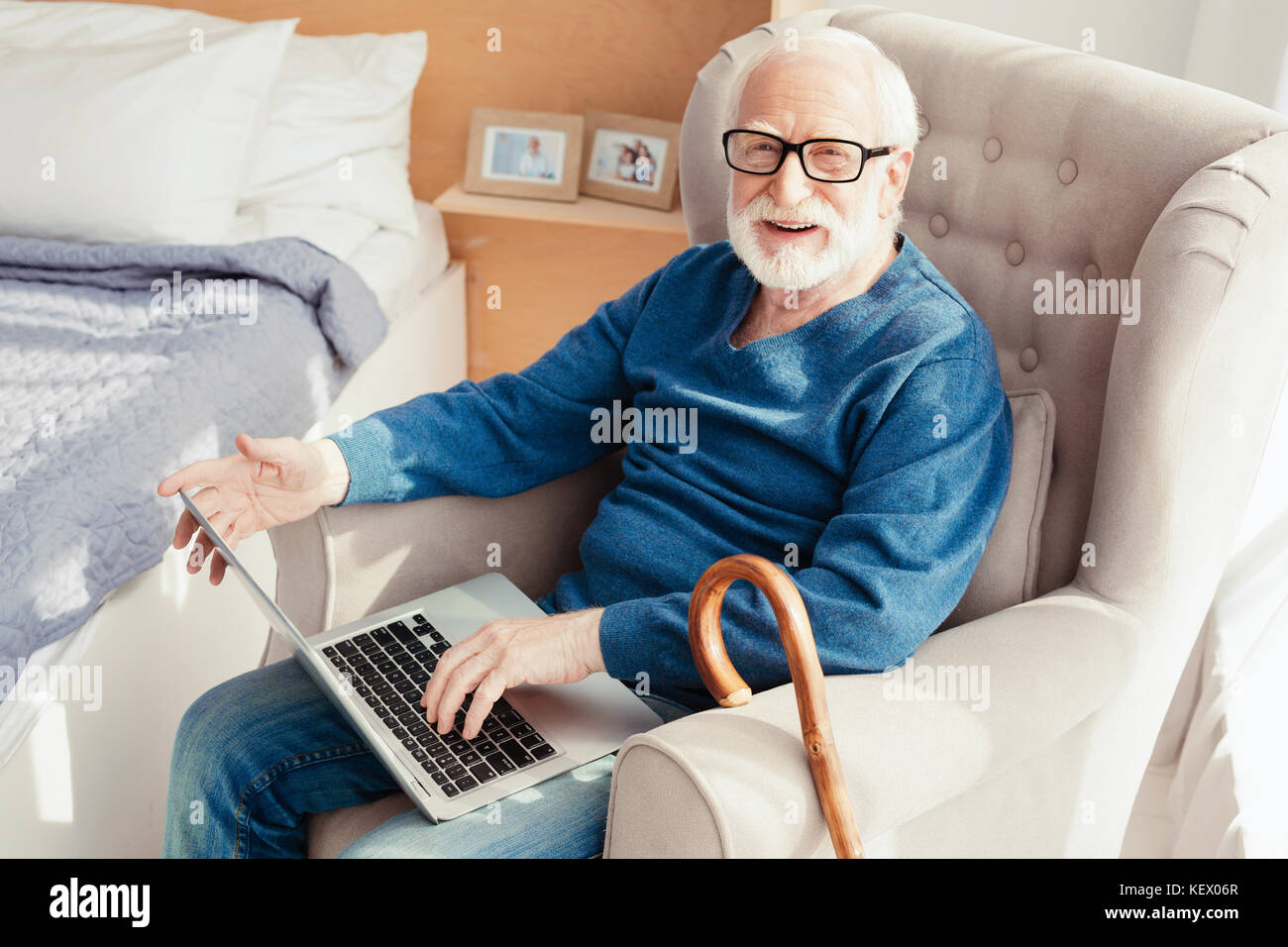 Happy pensioner working with computer Stock Photo - Alamy