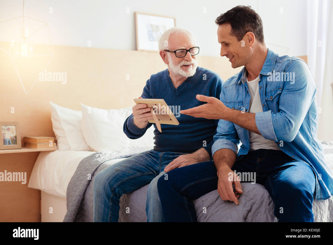 Positive delighted grandson talking with his grandpa Stock Photo - Alamy