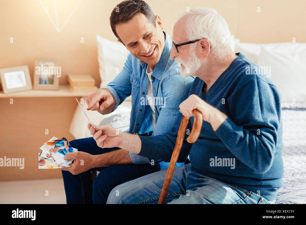 Delighted young man describing pictures Stock Photo - Alamy