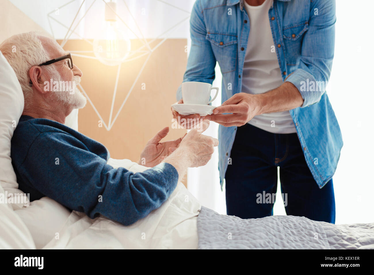 Profile photo of old man that being in bed Stock Photo - Alamy