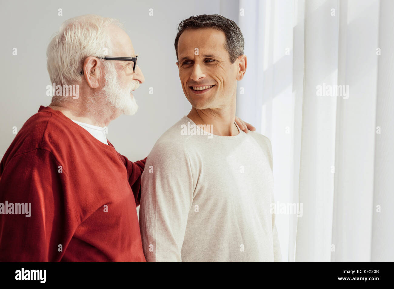 Positive delighted relatives having warm conversation Stock Photo - Alamy