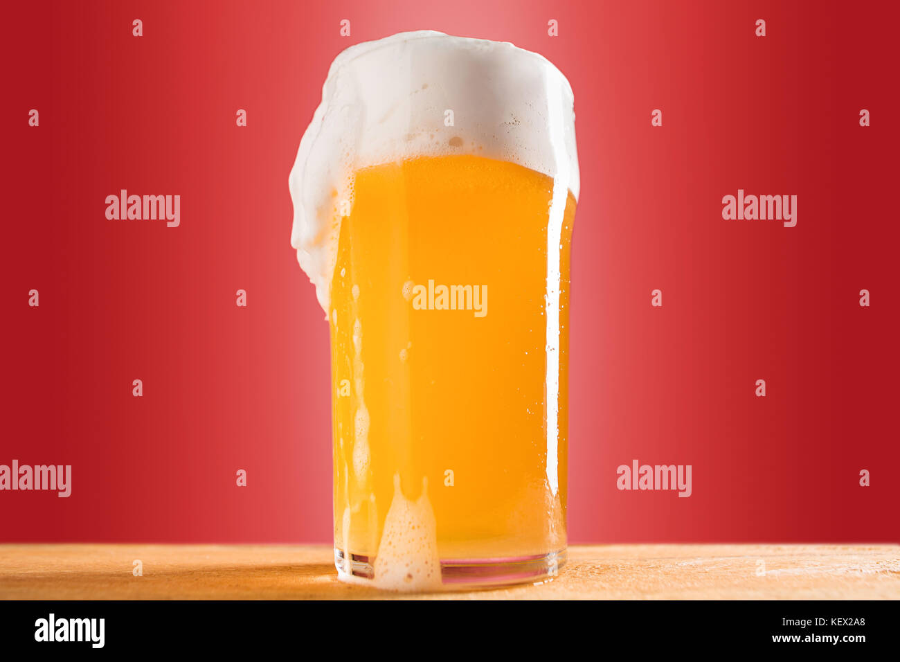 glass of cold frothy lager beer on an old wooden table Stock Photo - Alamy