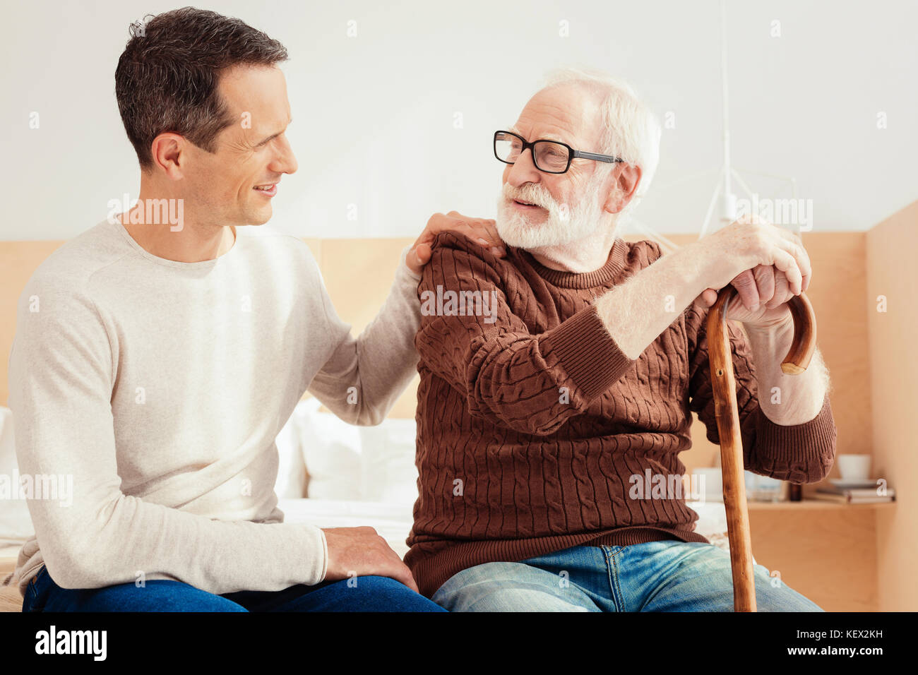 Delighted brunette putting his hand on shoulder Stock Photo - Alamy
