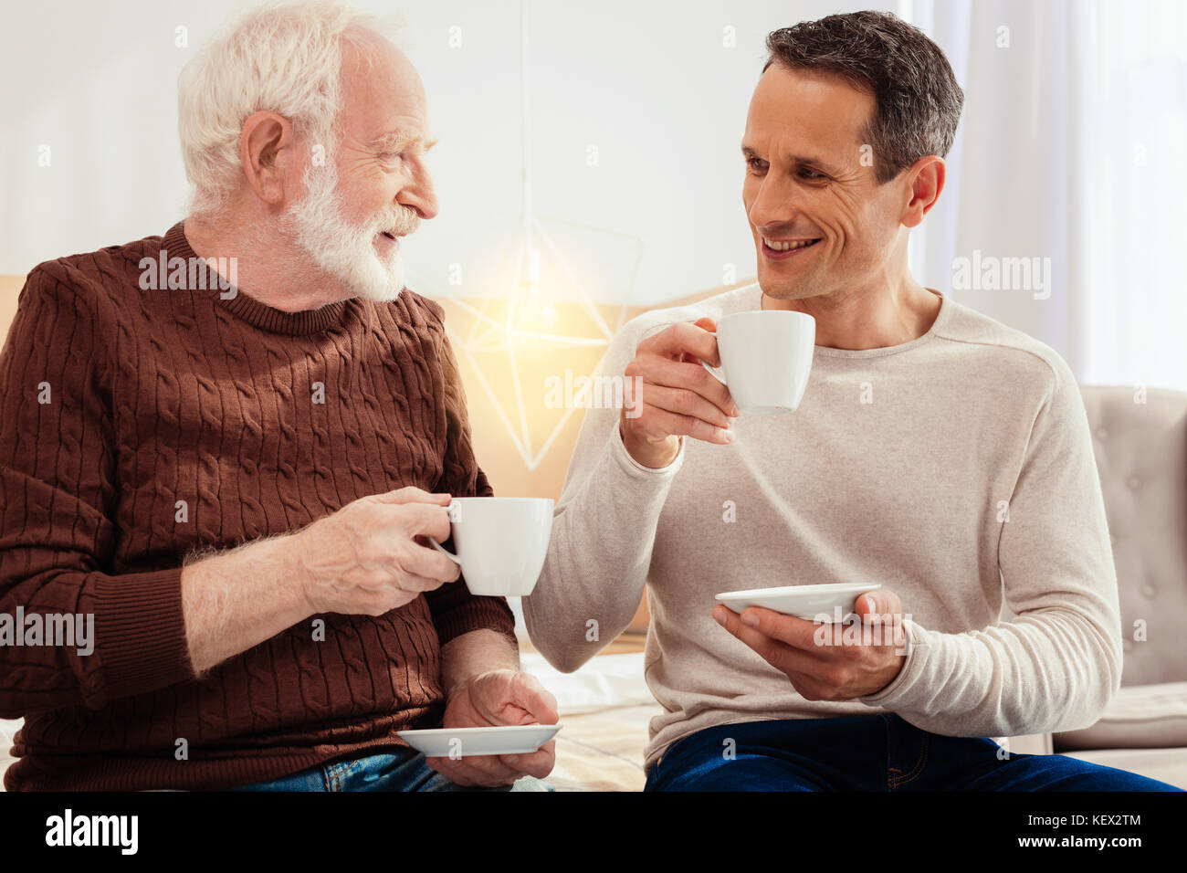 Delighted two men looking at each other Stock Photo - Alamy