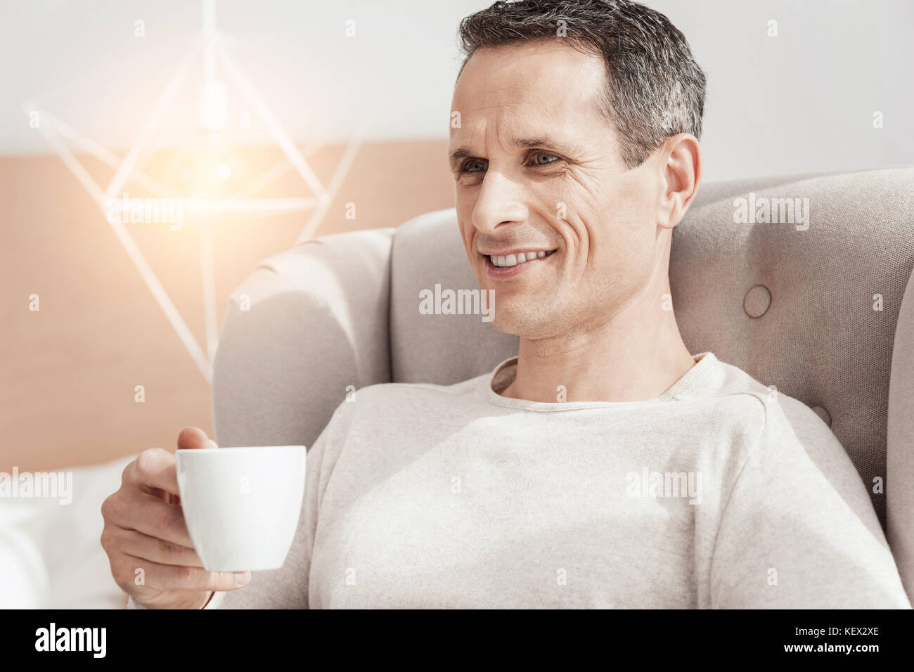 Positive delighted man looking forward Stock Photo - Alamy