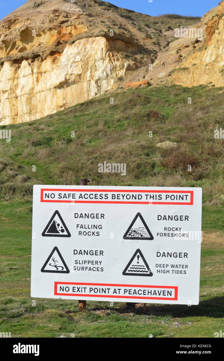 No safe access beyond this point sign beside cliff rock face at ...