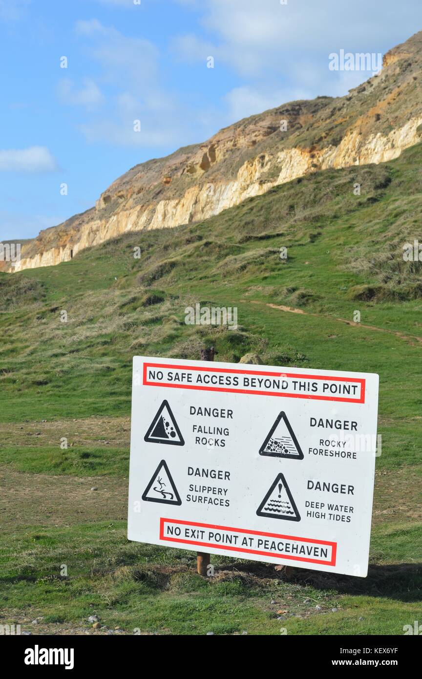 No safe access beyond this point sign beside cliff rock face at ...