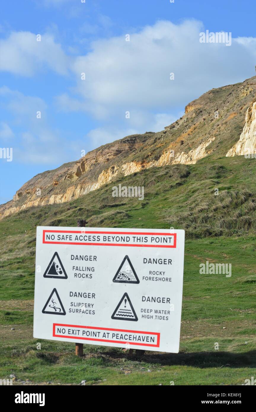 No safe access beyond this point sign beside cliff rock face at ...