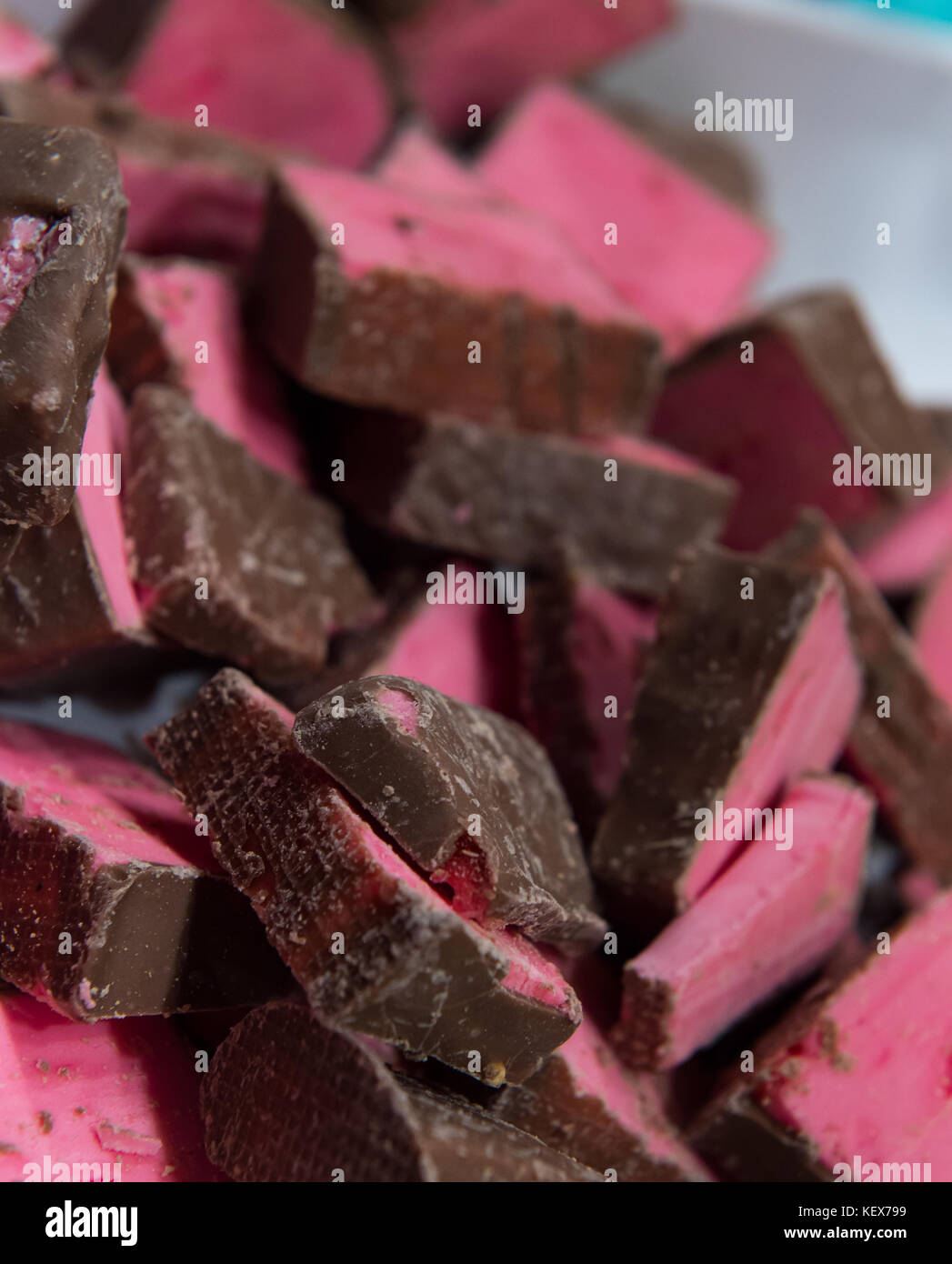 Delicious chunks of homemade strawberry and chocolate sweets on display ...
