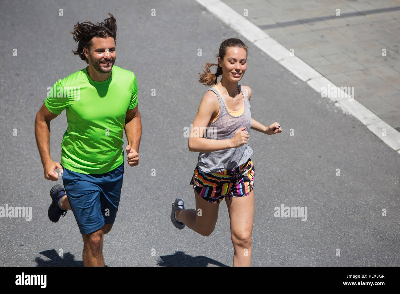 Top view at young couple jogging for fitness in urban environment on a ...