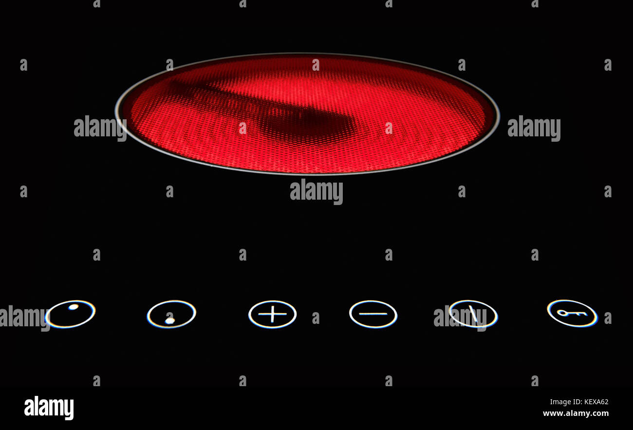 Modern induction cooker with control buttons. The electric hob closeup ...