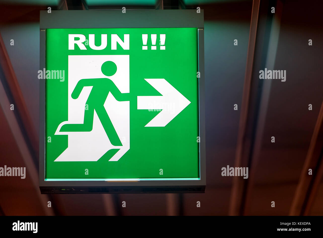 The emergency exit sign RUN! shows the direction of escape in case of ...