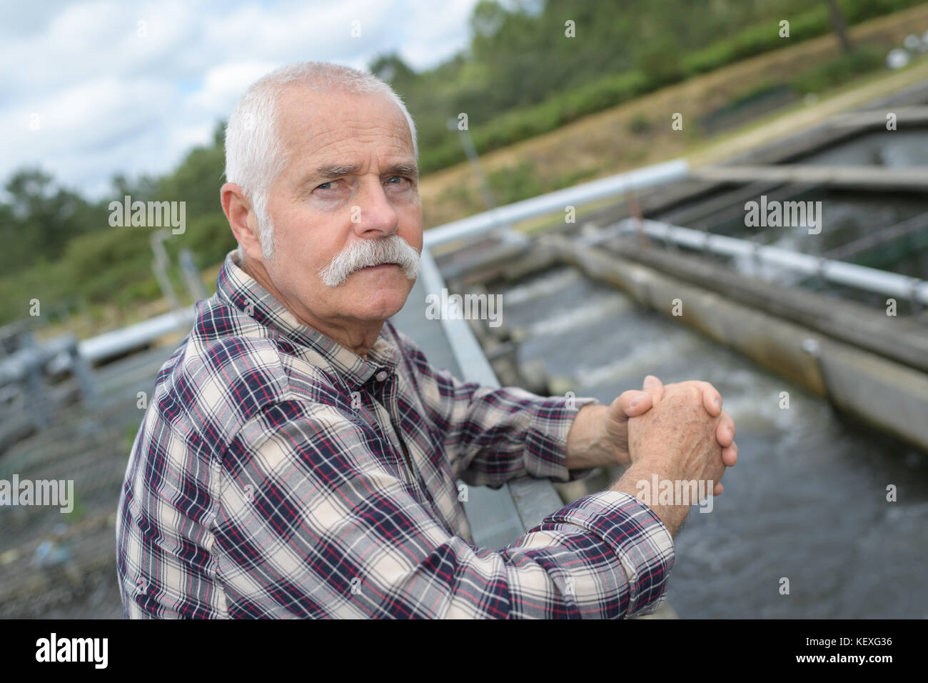 senior engineer standing on waste water treatment unit Stock Photo - Alamy