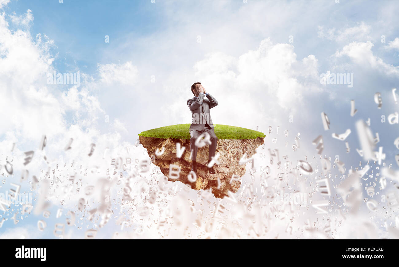 Young man floating in sky and do not want to see anything Stock Photo ...