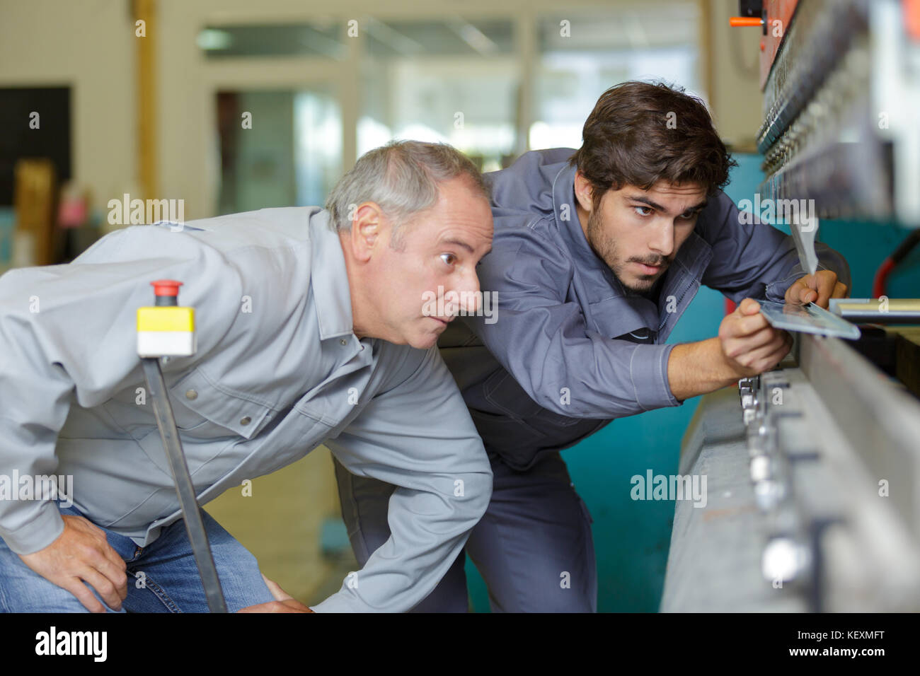 teacher showing machine to student Stock Photo - Alamy