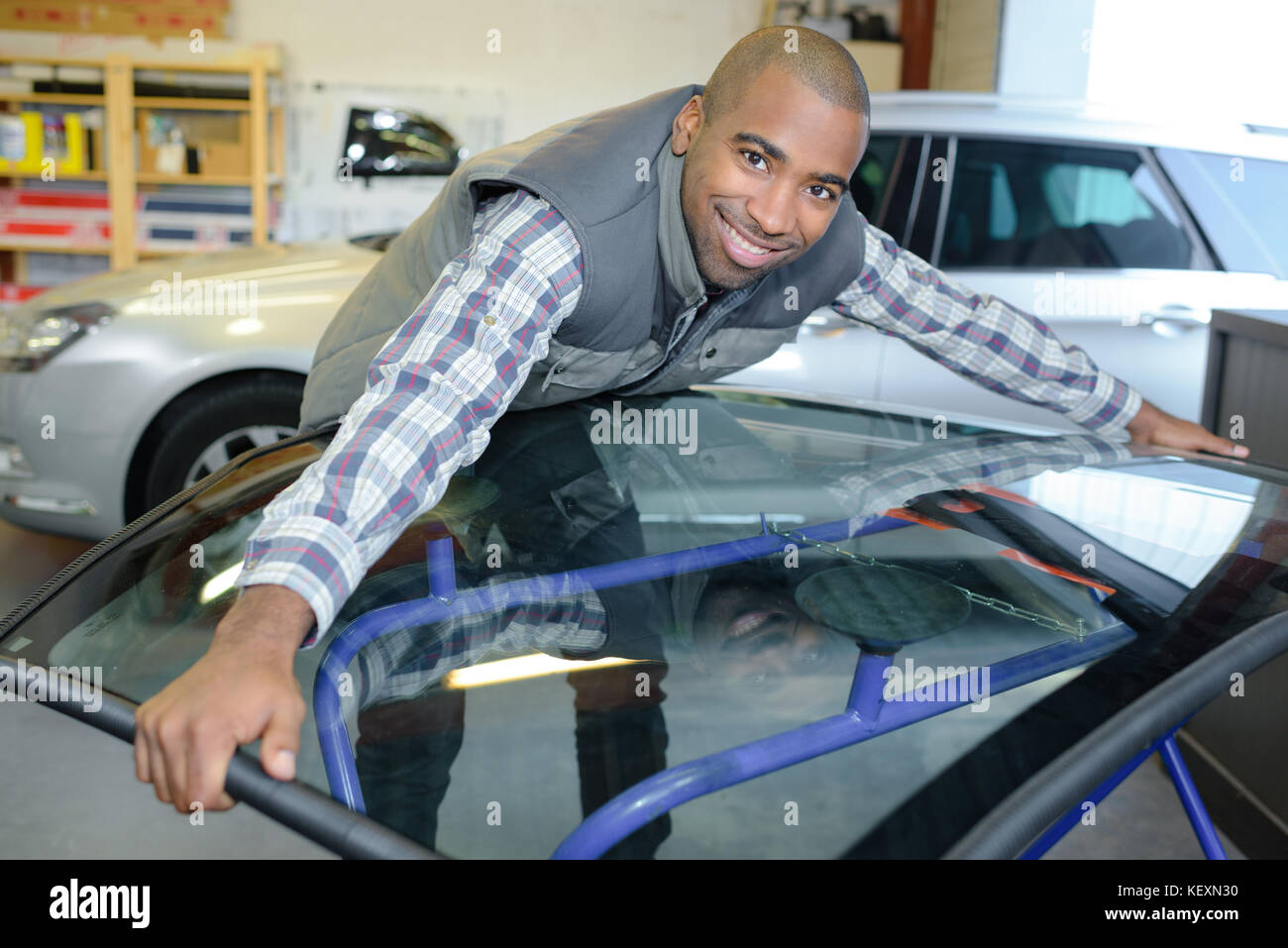Man carrying windshield Stock Photo - Alamy