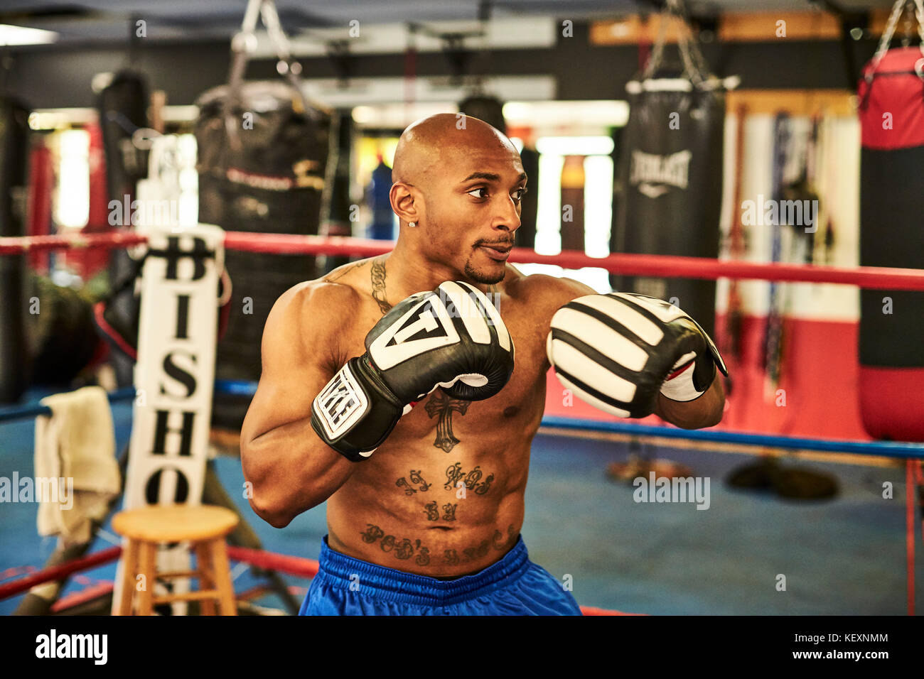 Side view of male boxer training inside boxing ring, Taunton ...