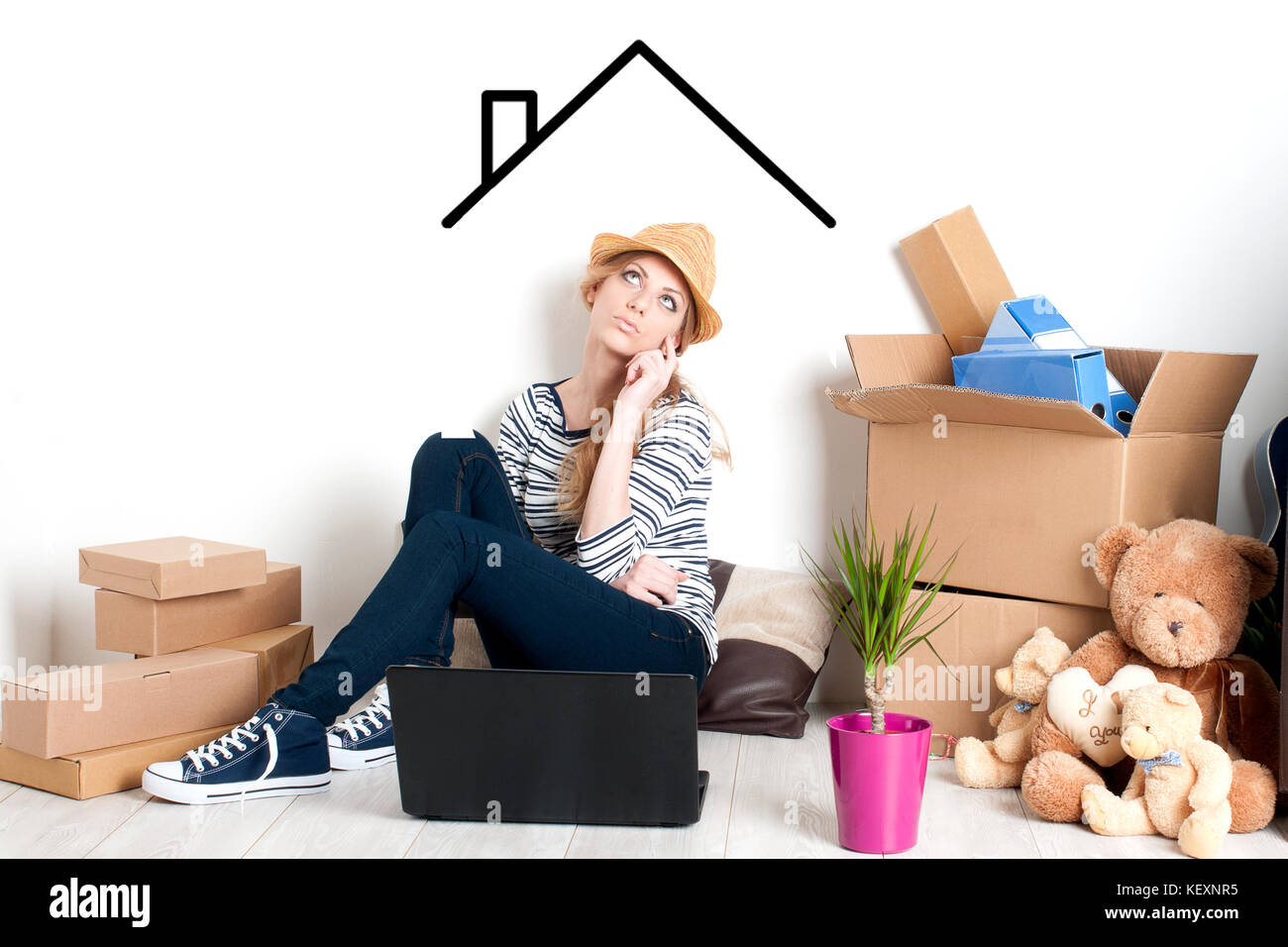 Lady thinking moving home Stock Photo - Alamy