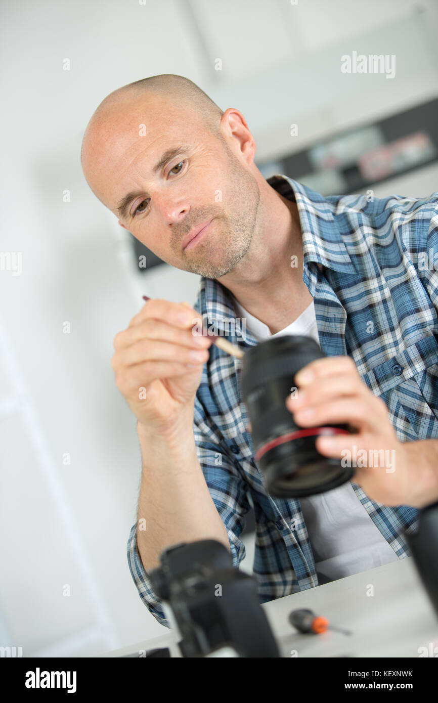 Technician working on camera lens Stock Photo - Alamy
