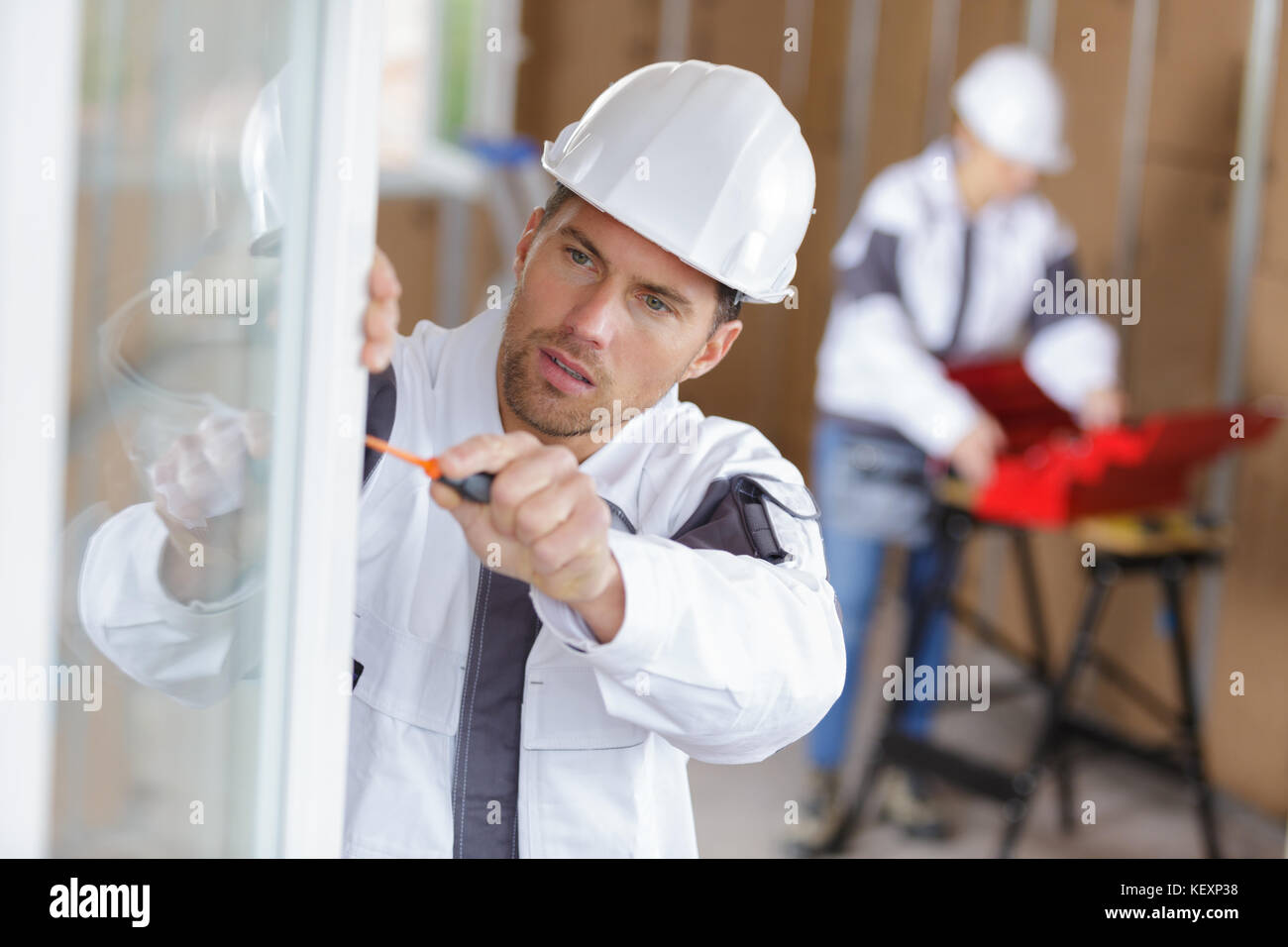 construction worker installing window in house Stock Photo - Alamy