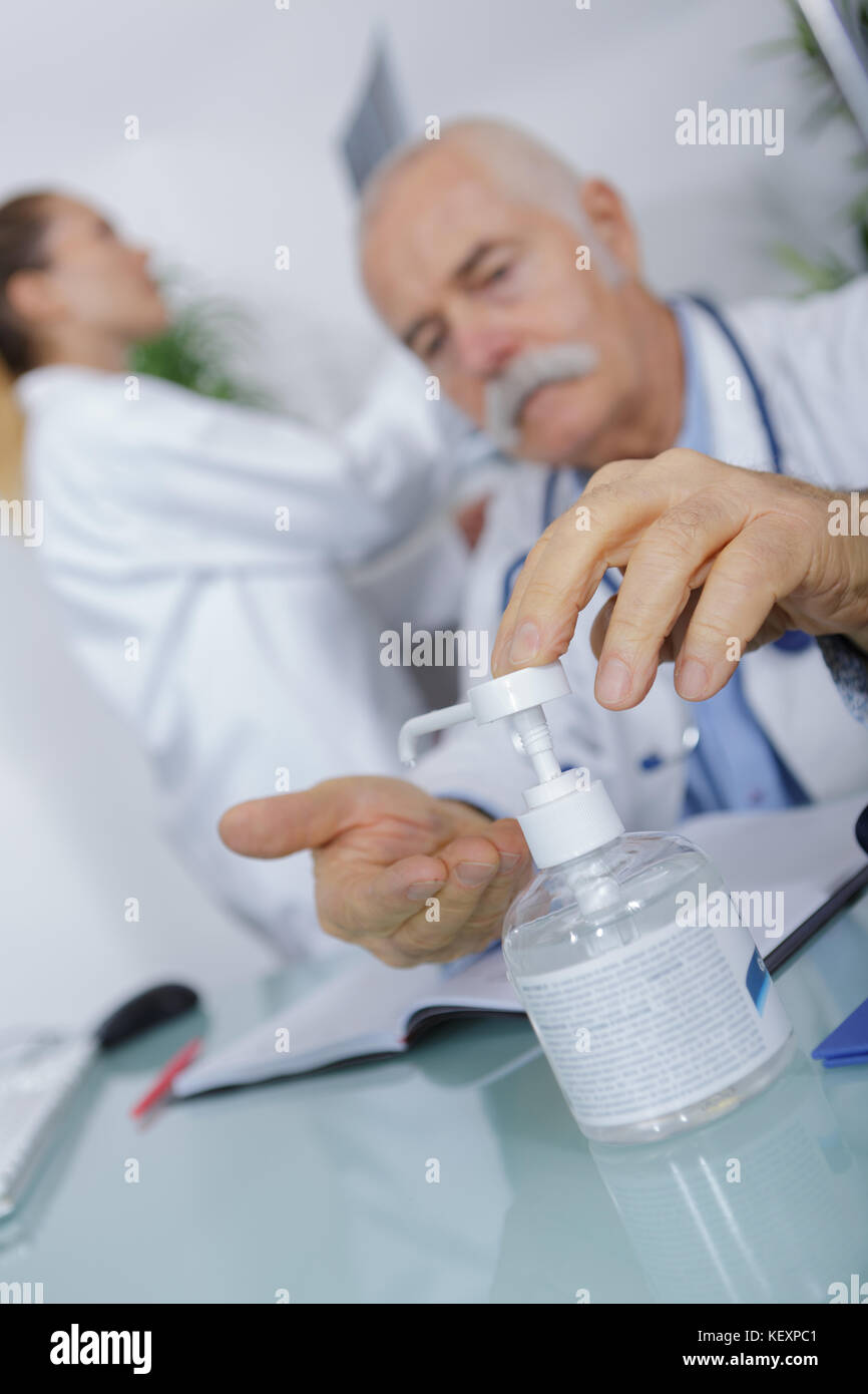 senior doctor hand pushing pump bottle Stock Photo - Alamy