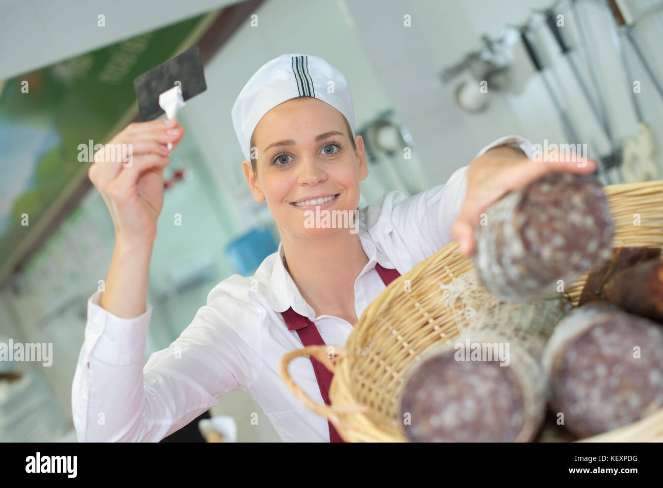 a butchery vendor placing a price tag on meat Stock Photo - Alamy