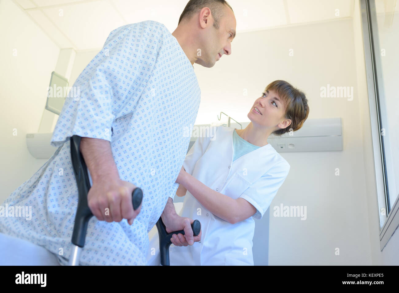 Female physiotherapist helping positive hi-res stock photography and ...