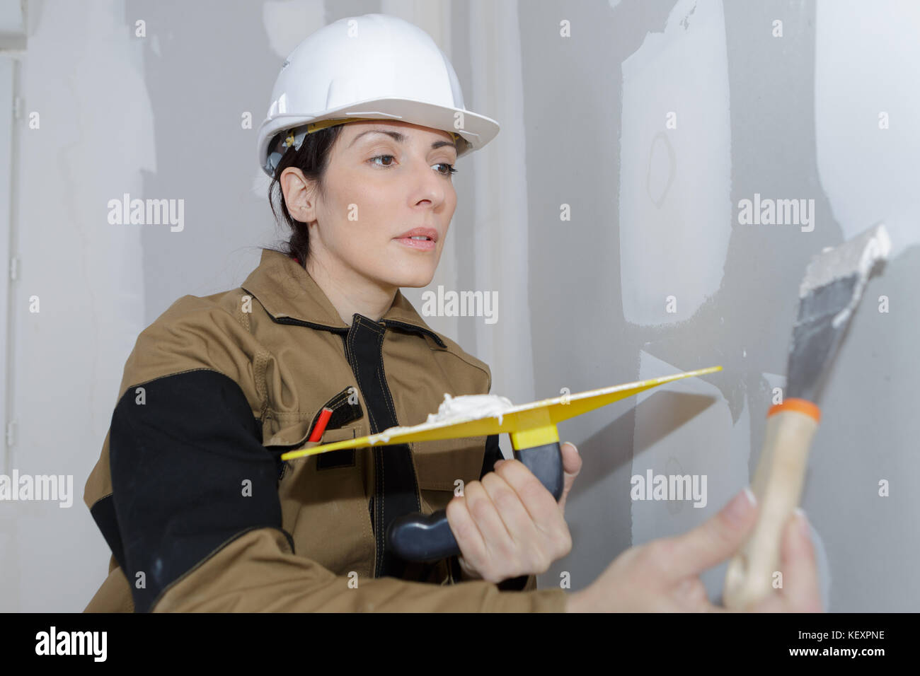 Construction female helmet plastering hi-res stock photography and ...