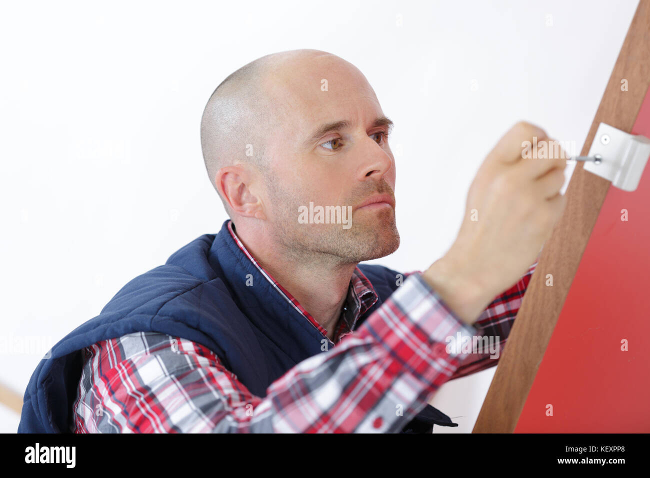 young locksmith installing a lock on a new door Stock Photo - Alamy