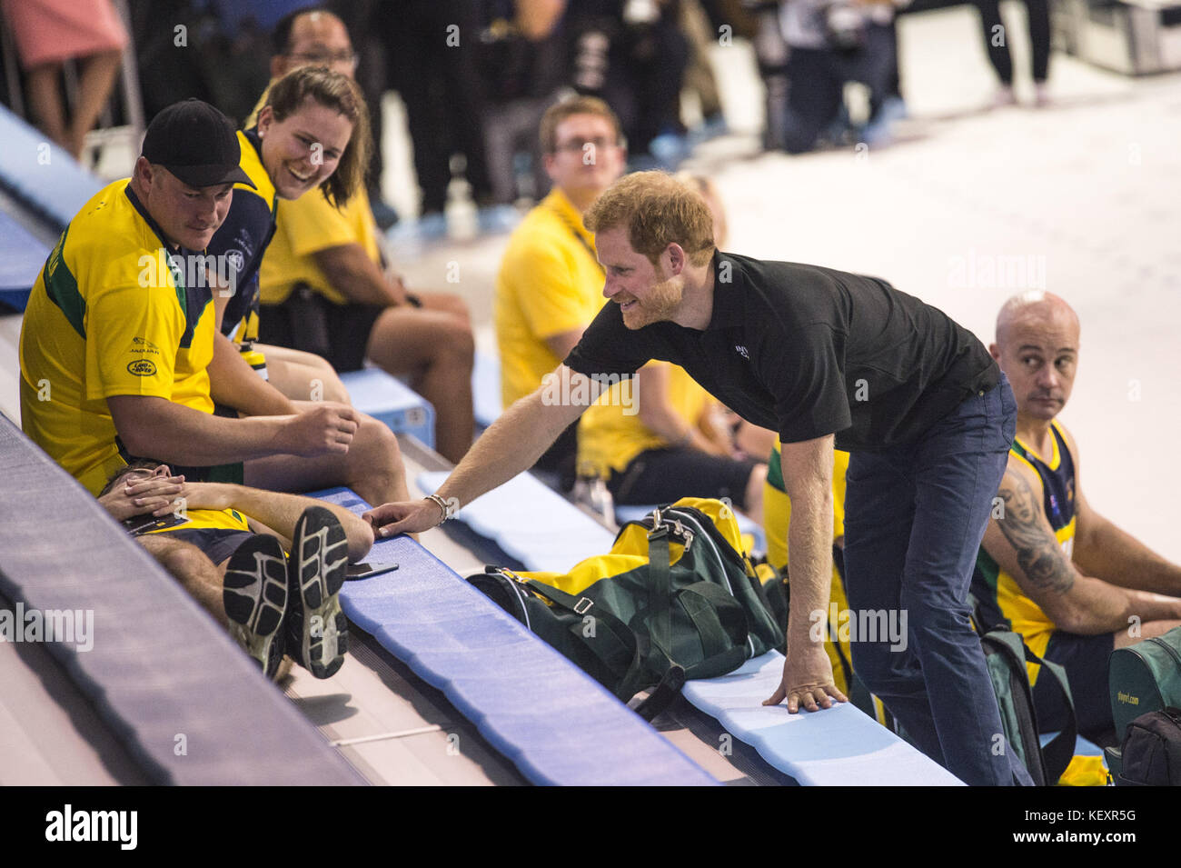 Prince Harry sneaks up on a sleeping Australian athlete as he attends ...