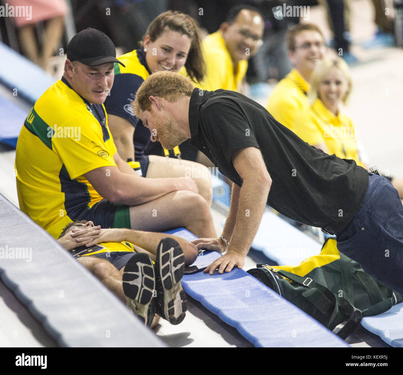 Prince Harry sneaks up on a sleeping Australian athlete as he attends ...