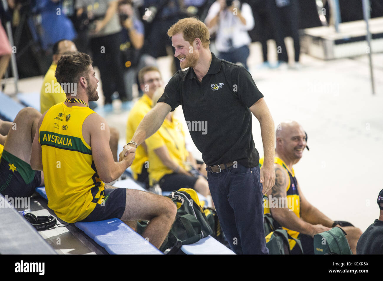 Prince Harry sneaks up on a sleeping Australian athlete as he attends ...