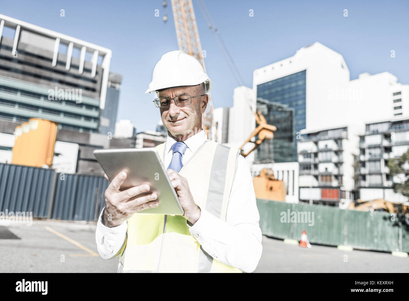 Construction manager controlling building site and tablet device Stock ...